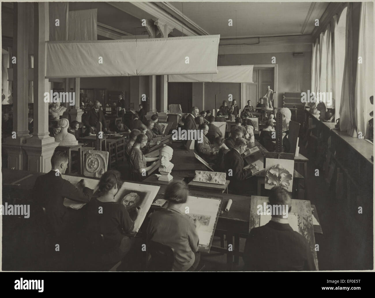 This drawing class shows students working on their artistic skills. The ...