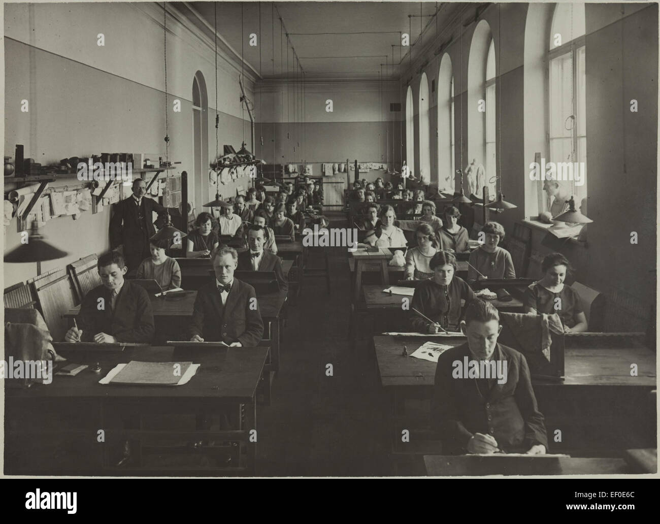 A drawing class, captured in a historical photograph, shows students ...