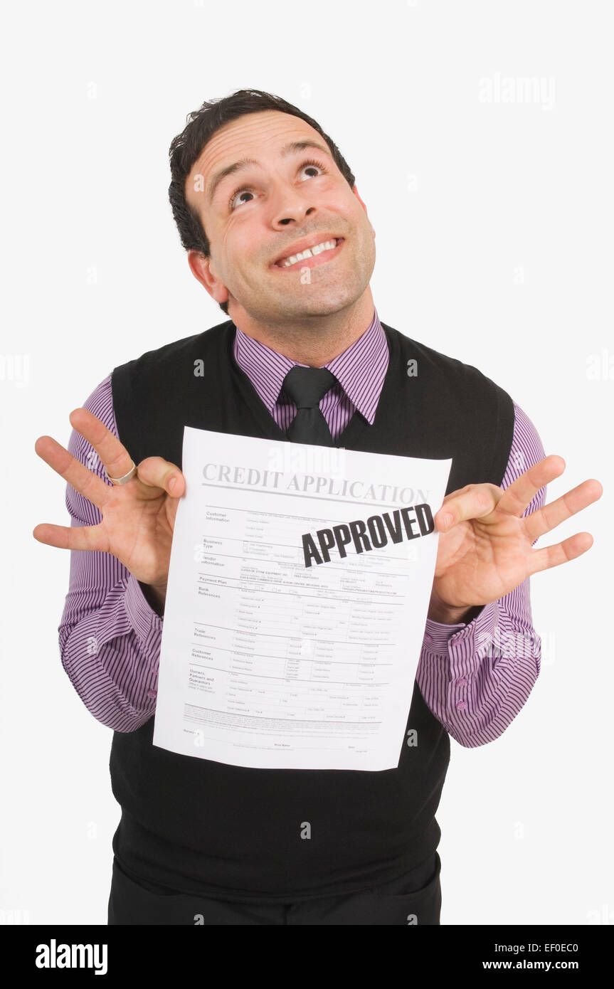 Man holding approved credit application Stock Photo - Alamy