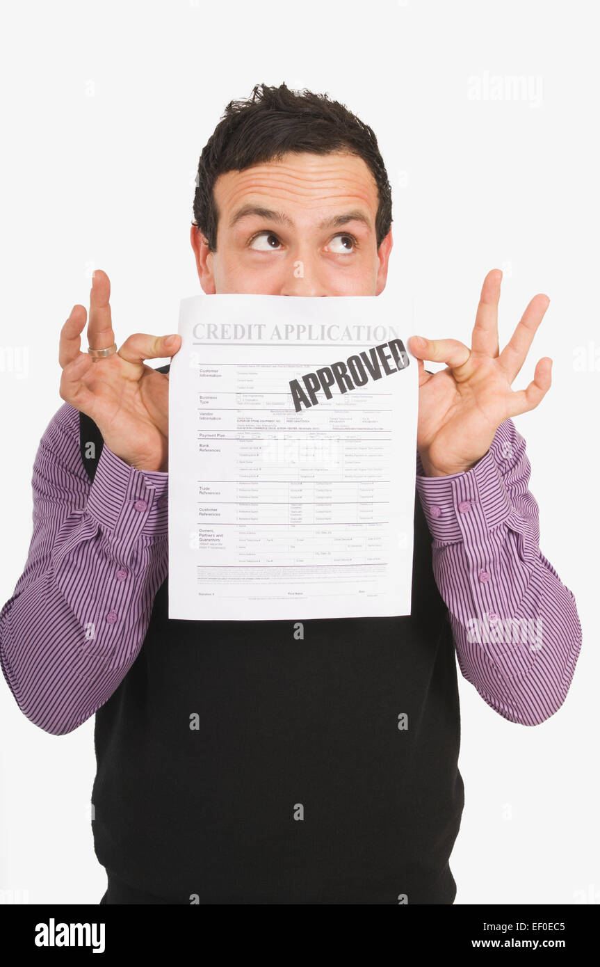 Man holding approved credit application Stock Photo - Alamy