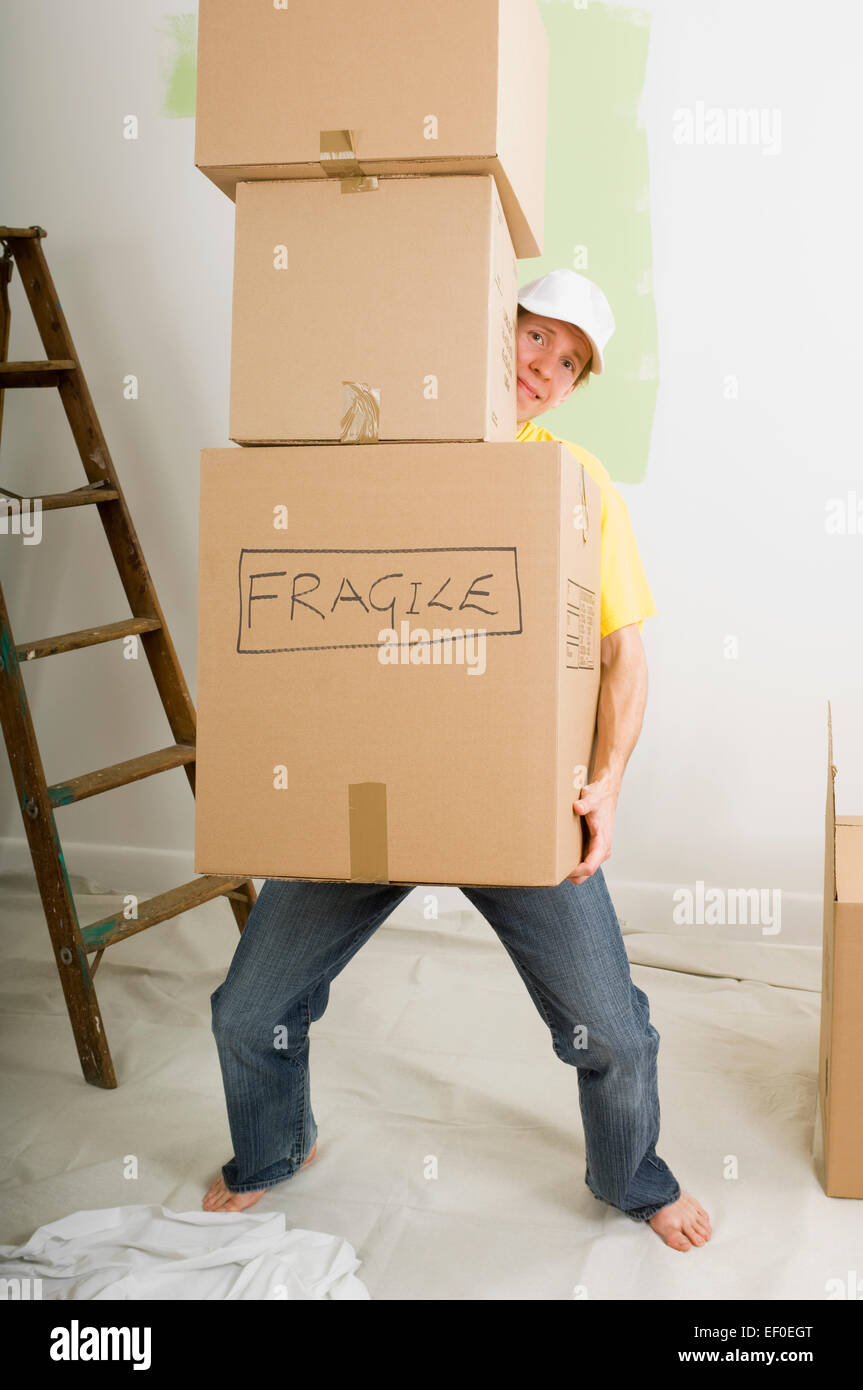 Man carrying heavy boxes Stock Photo - Alamy