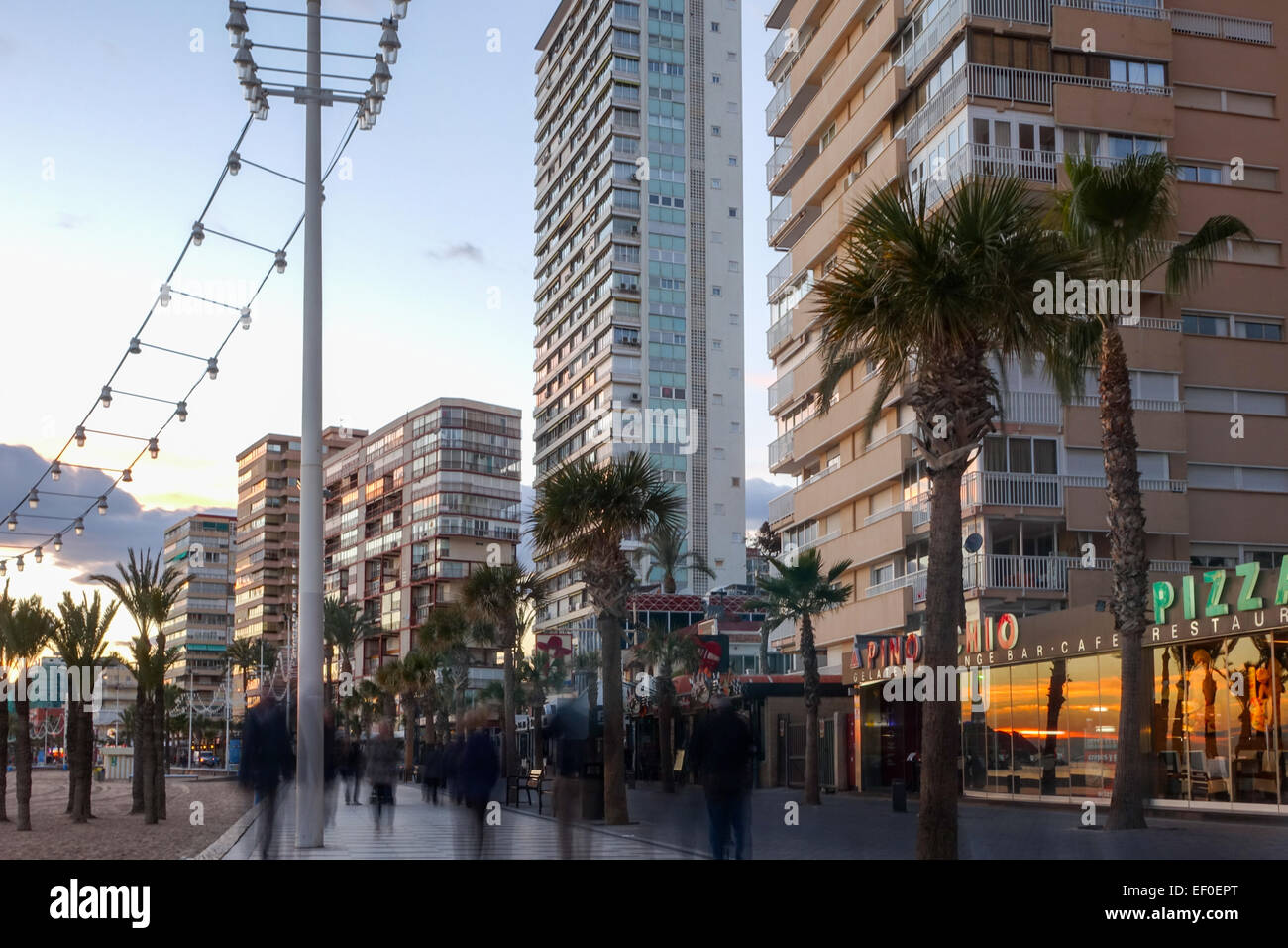 Benidorm high rise apartments on seafront at dusk. Pinochio Pizza shop ...