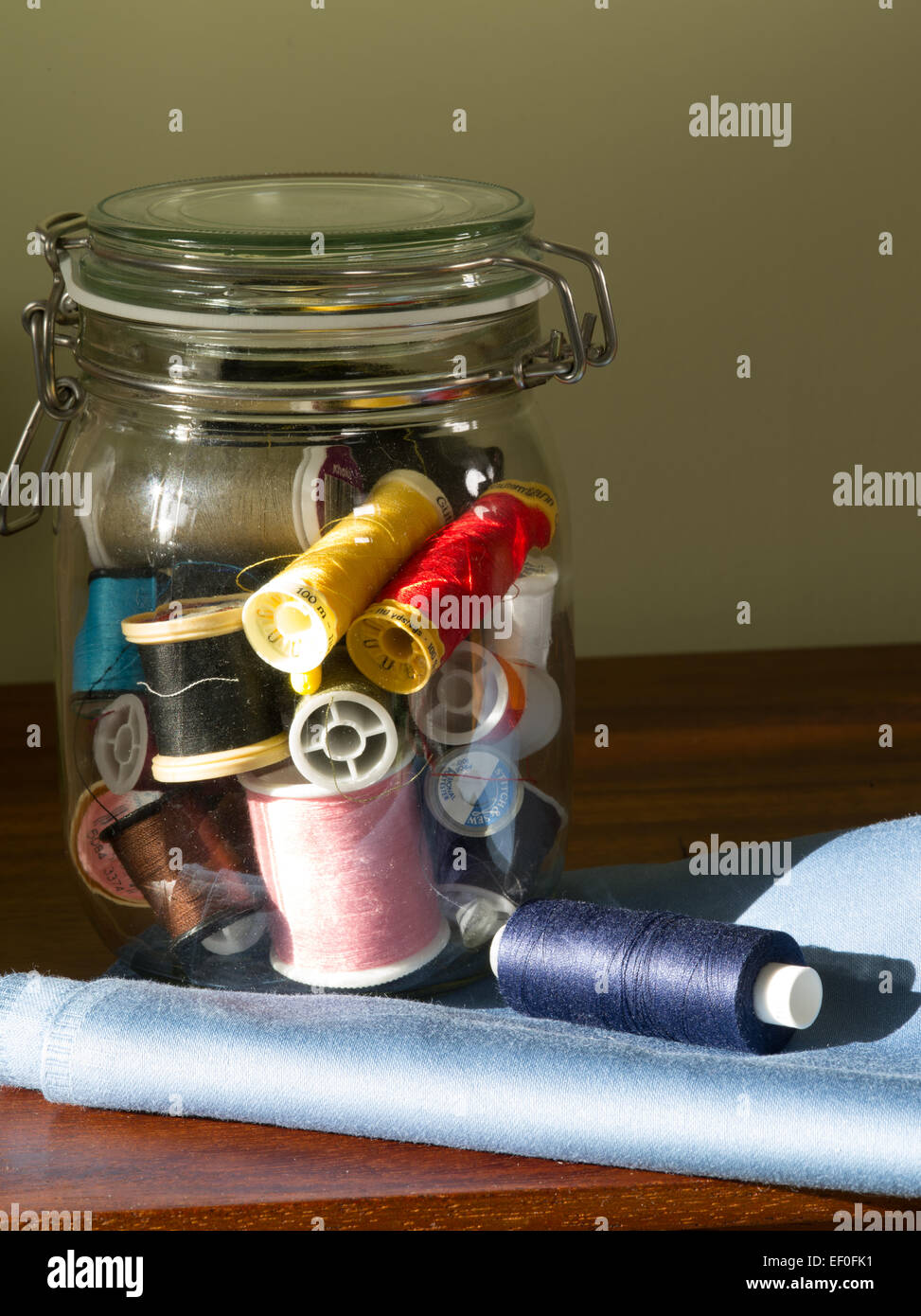 sewing thread in jar Stock Photo - Alamy