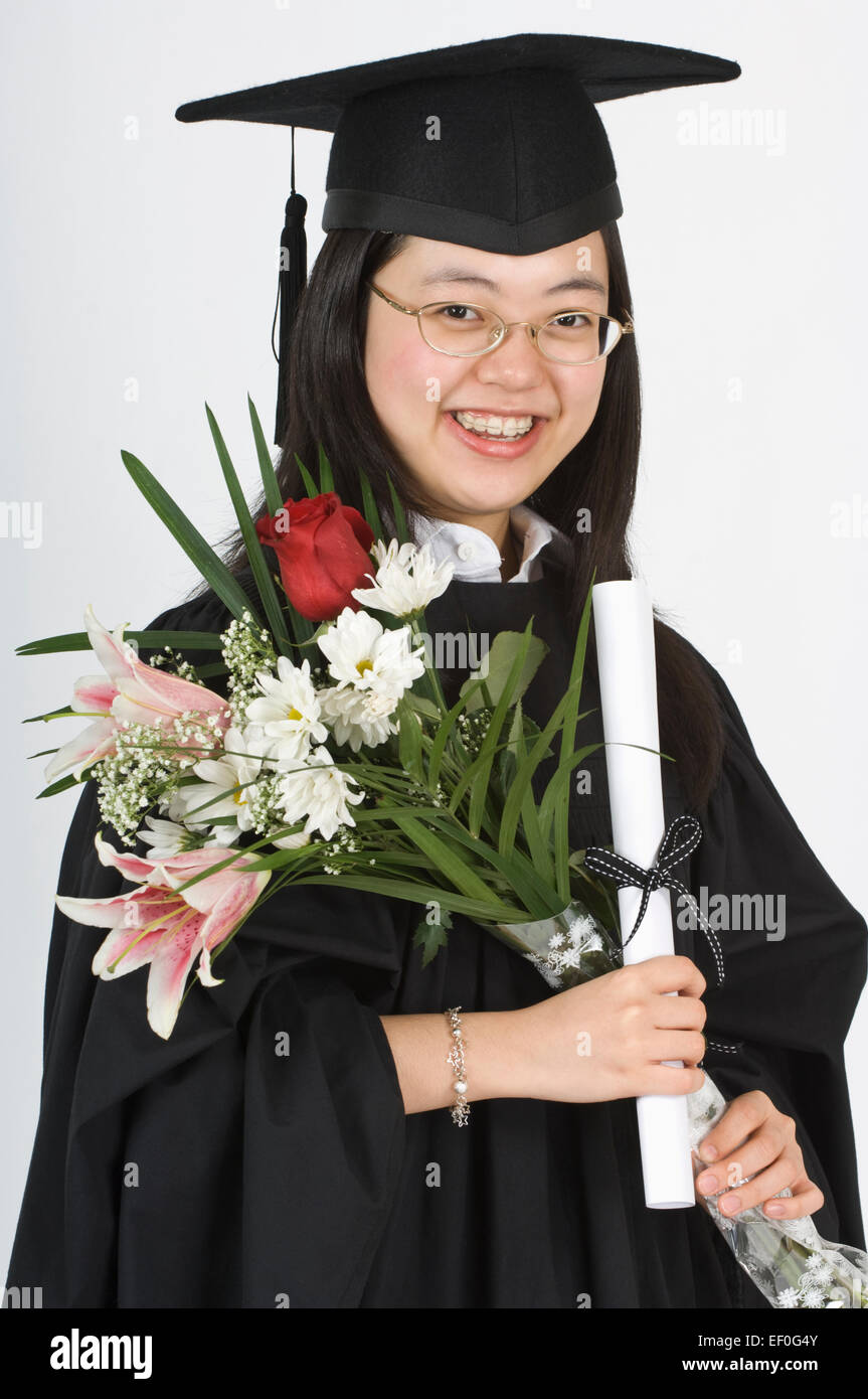 Young girl wearing a graduation cap and gown Stock Photo - Alamy