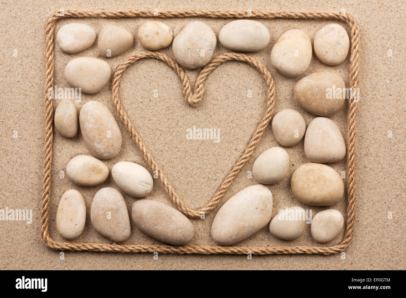 White heart stone on sand hi-res stock photography and images - Alamy