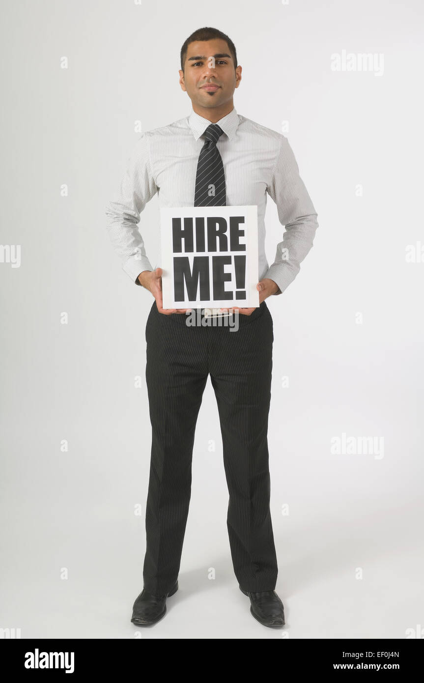 Man holding a hire me sign Stock Photo - Alamy