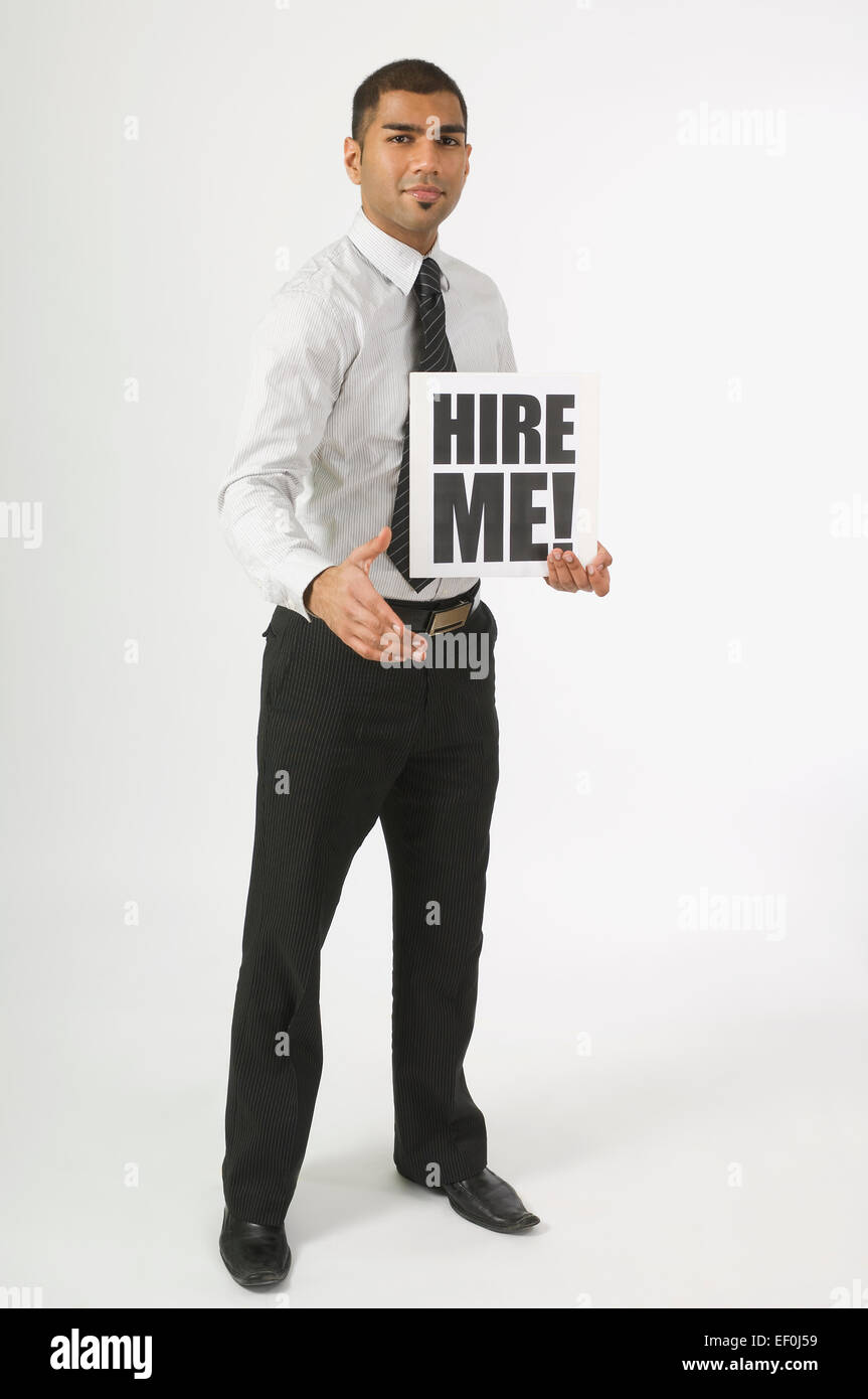 Man holding a hire me sign Stock Photo - Alamy