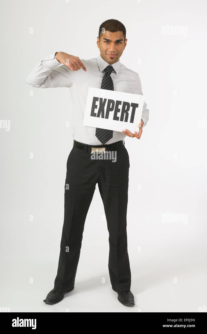 Man holding a sign that says expert Stock Photo - Alamy