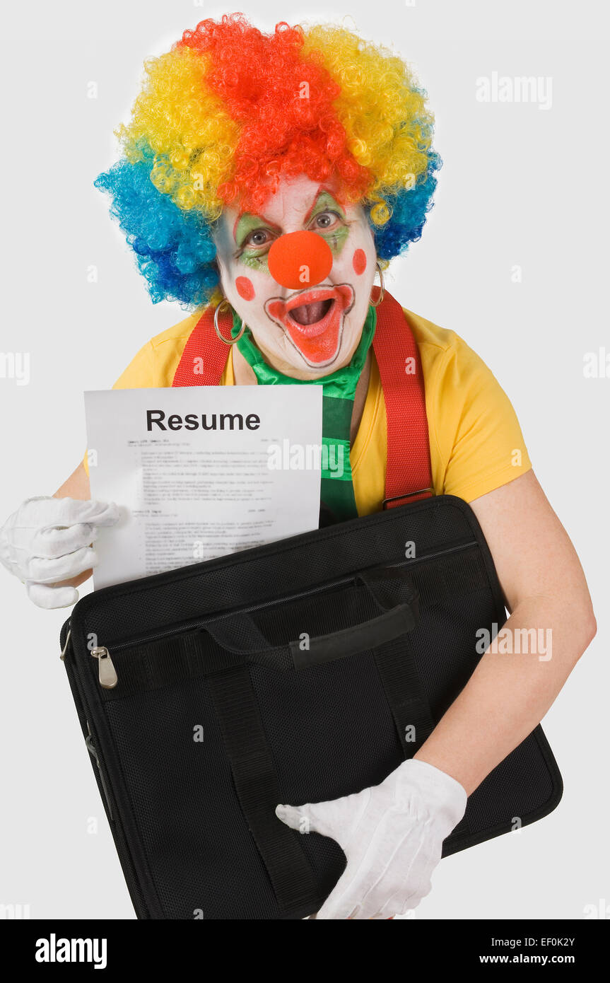 Clown putting resume in briefcase Stock Photo - Alamy