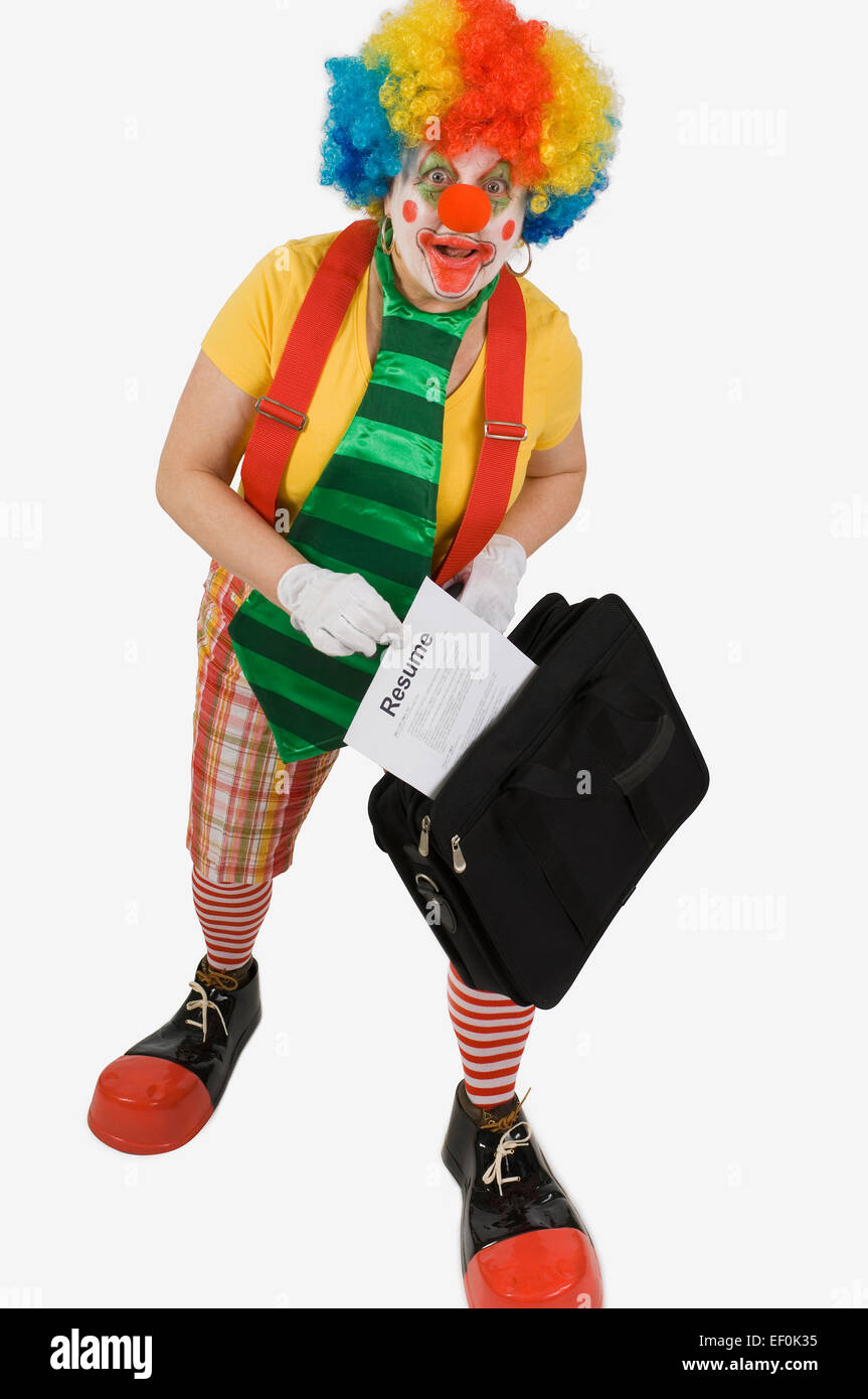 Clown putting resume in briefcase Stock Photo - Alamy