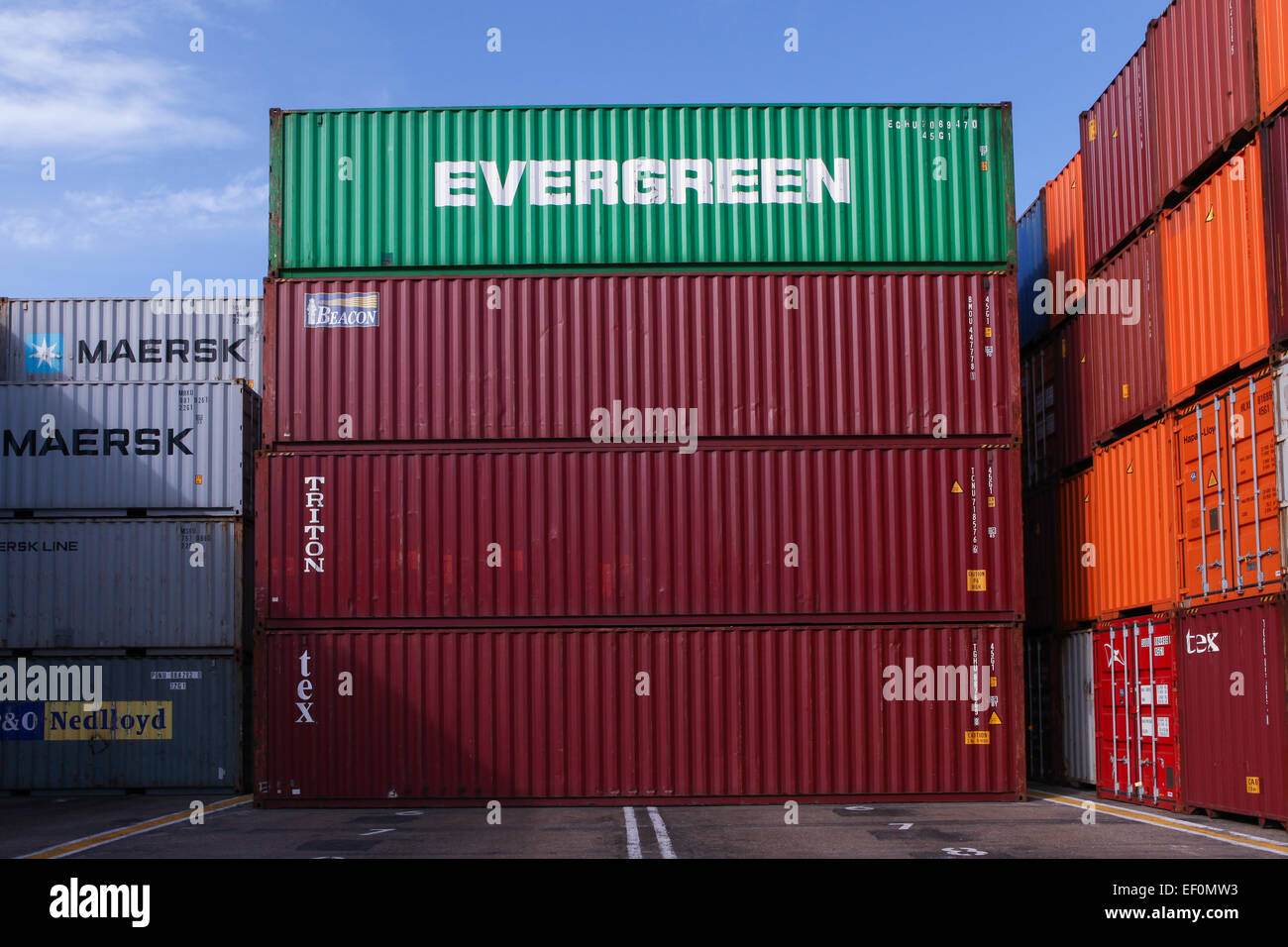 Various brands and colors of shipping containers stacked Stock Photo ...