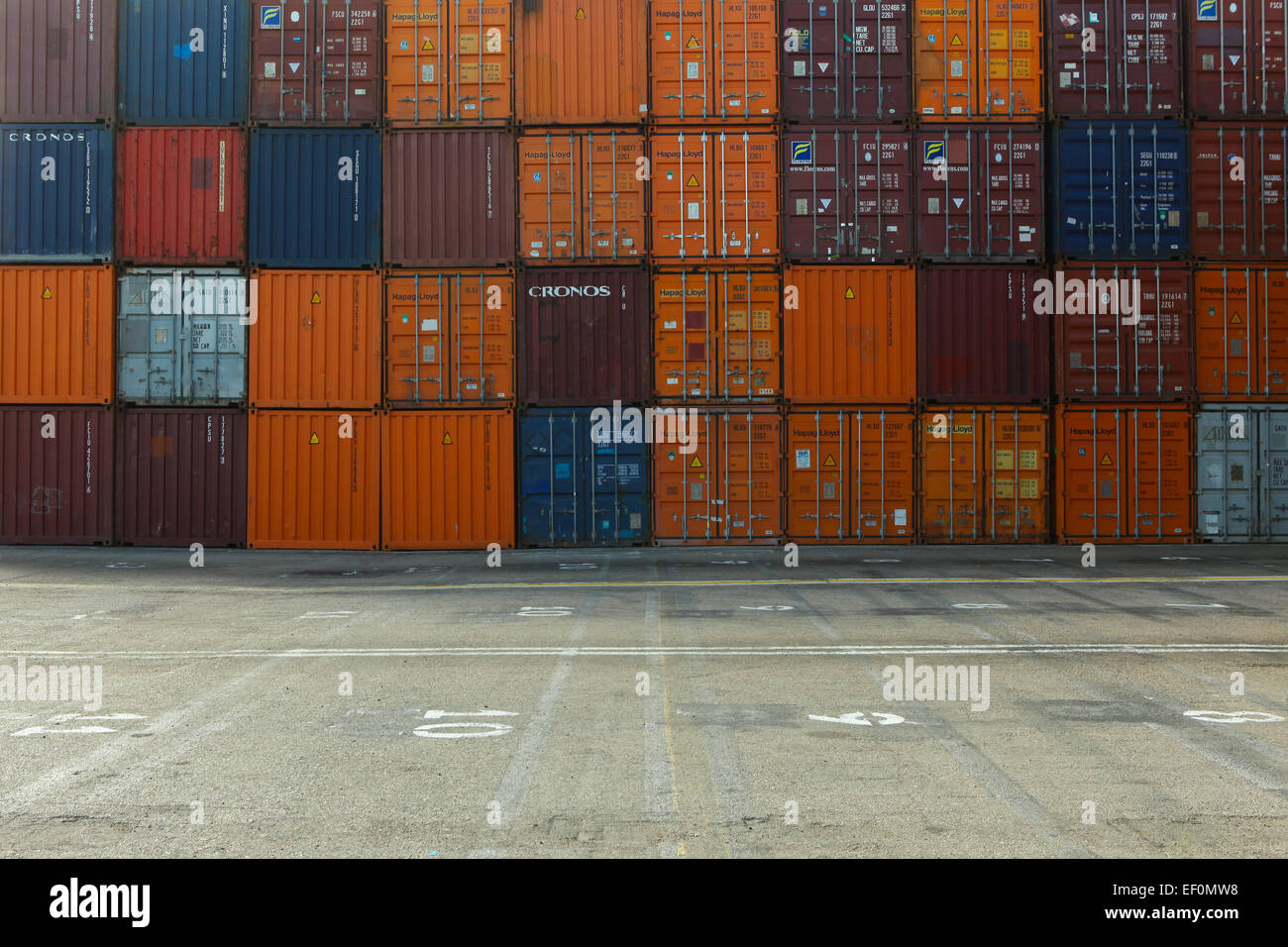 Various brands and colors of shipping containers stacked Stock Photo ...