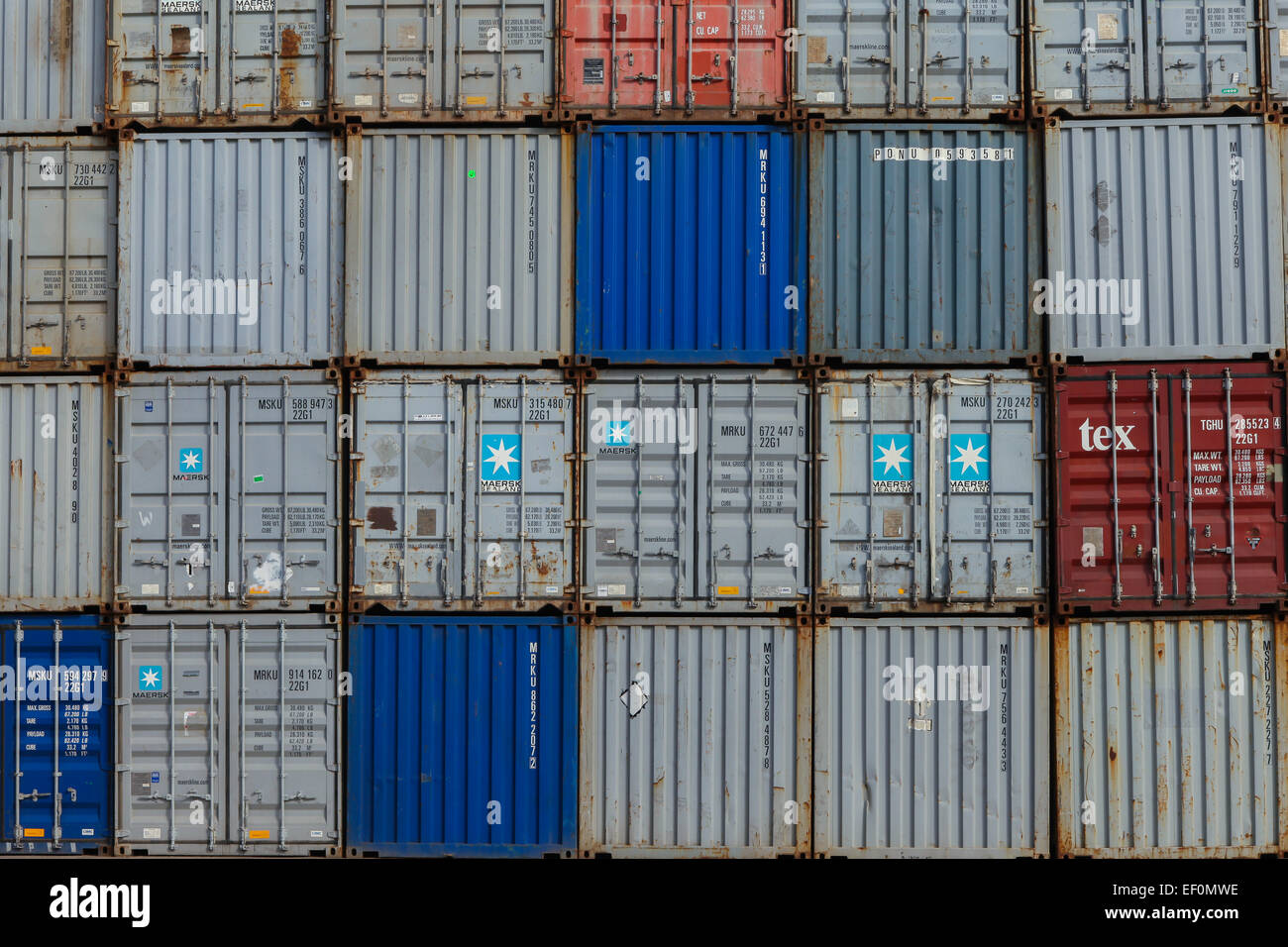 Various brands and colors of shipping containers stacked Stock Photo ...