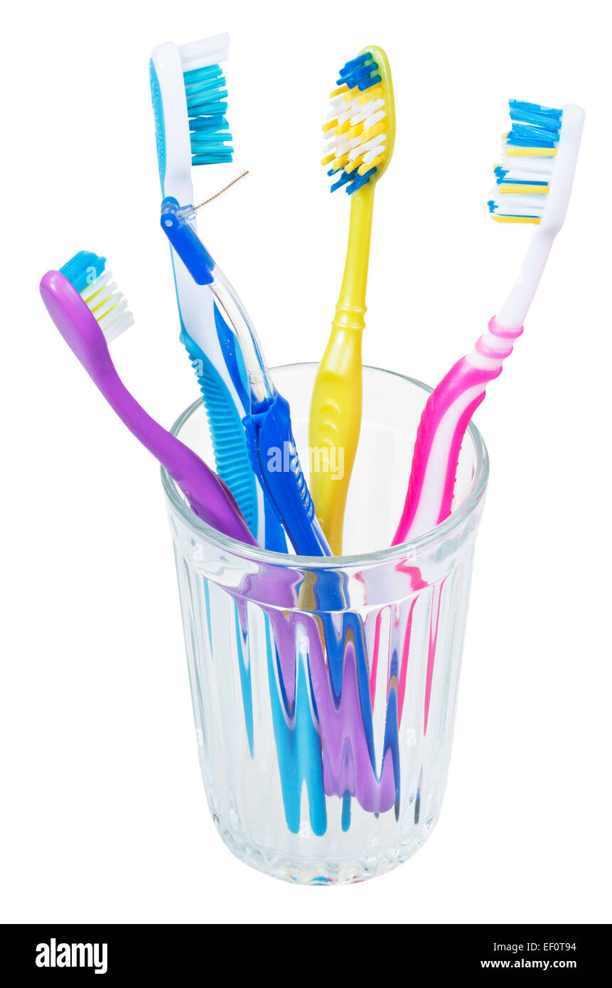 four tooth brushes and interdental brush in glass - family set of ...