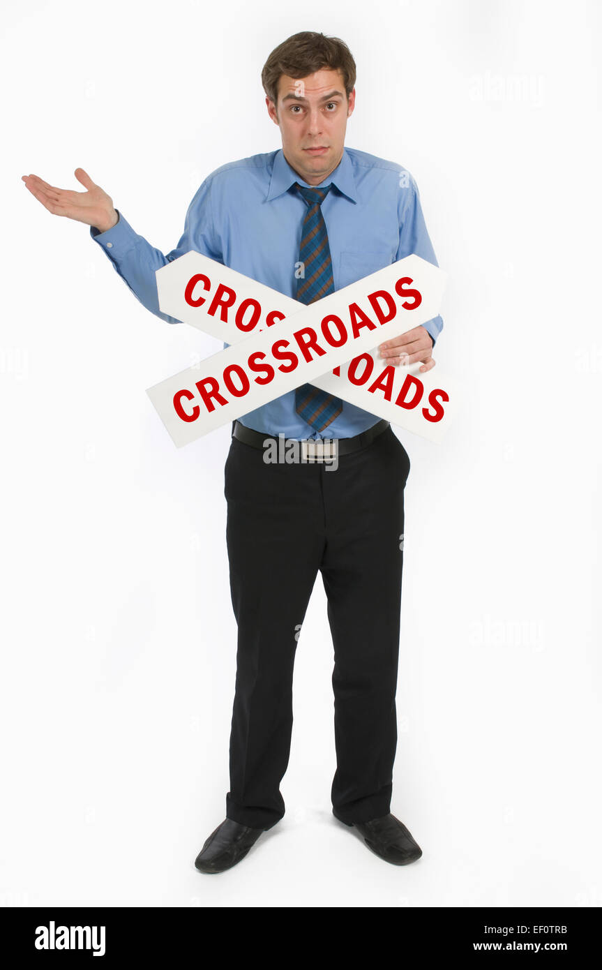 Businessman at a crossroads Stock Photo - Alamy