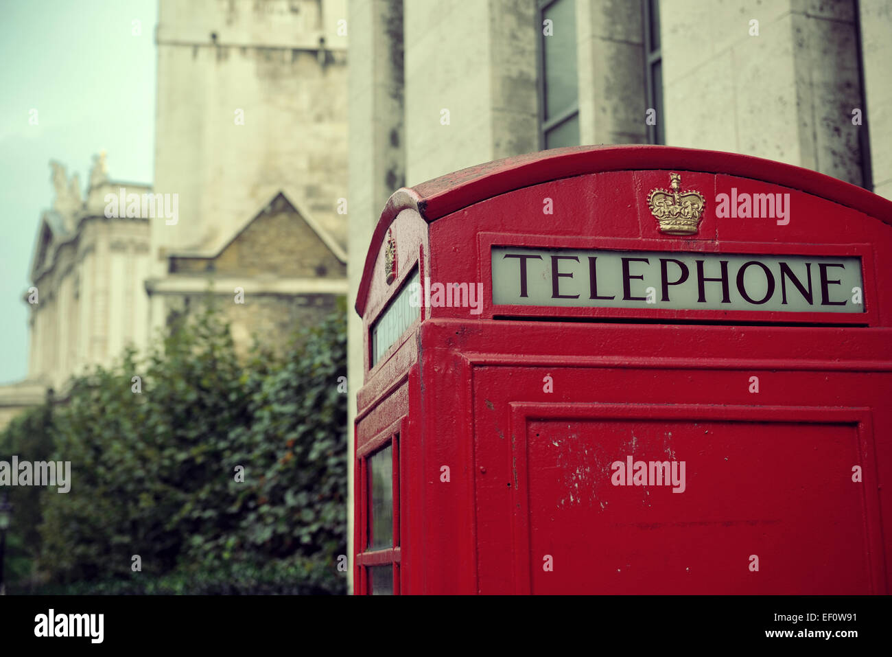 Red telephone booth in street with historical architecture in London ...