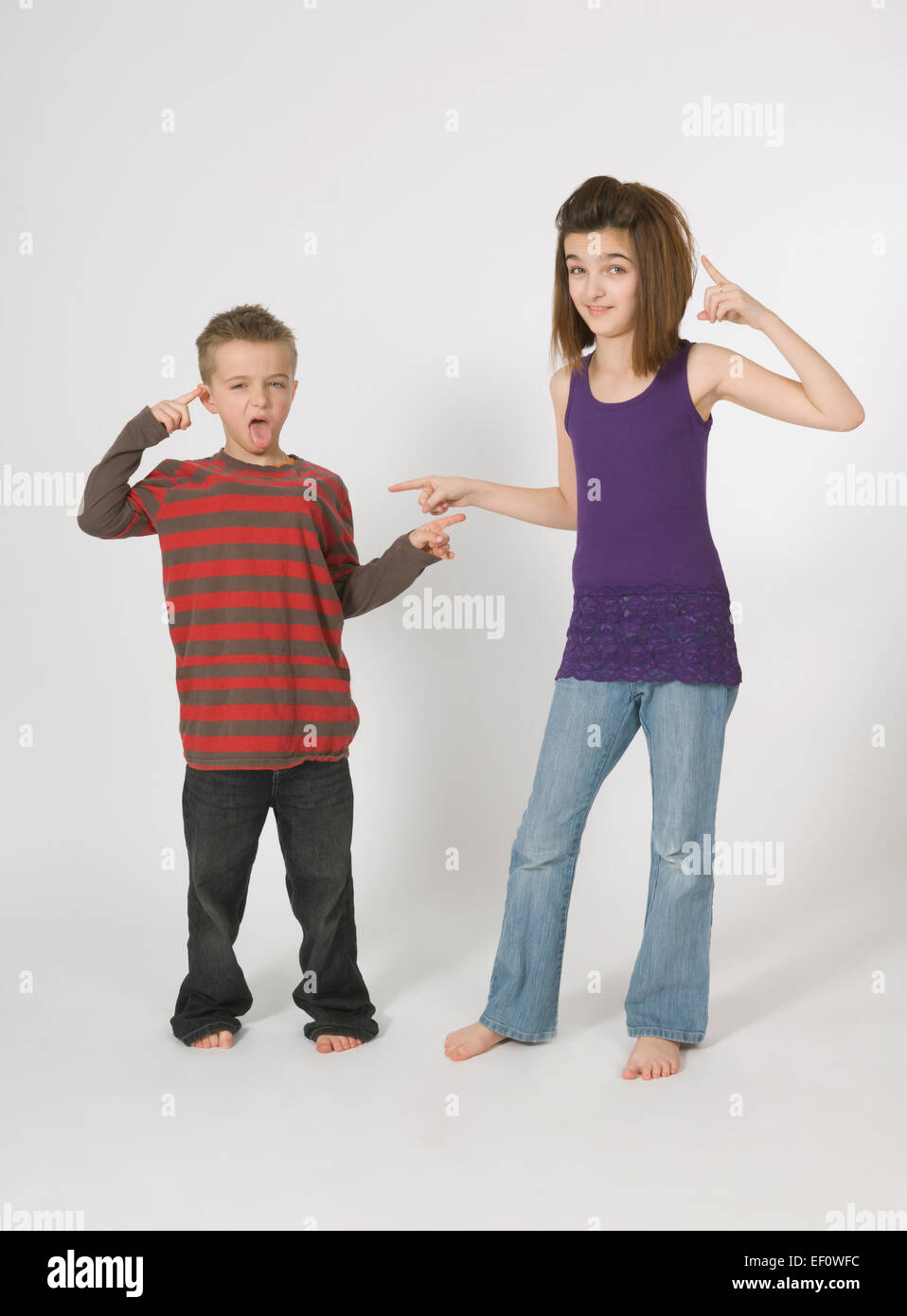 Siblings pointing at each other Stock Photo - Alamy