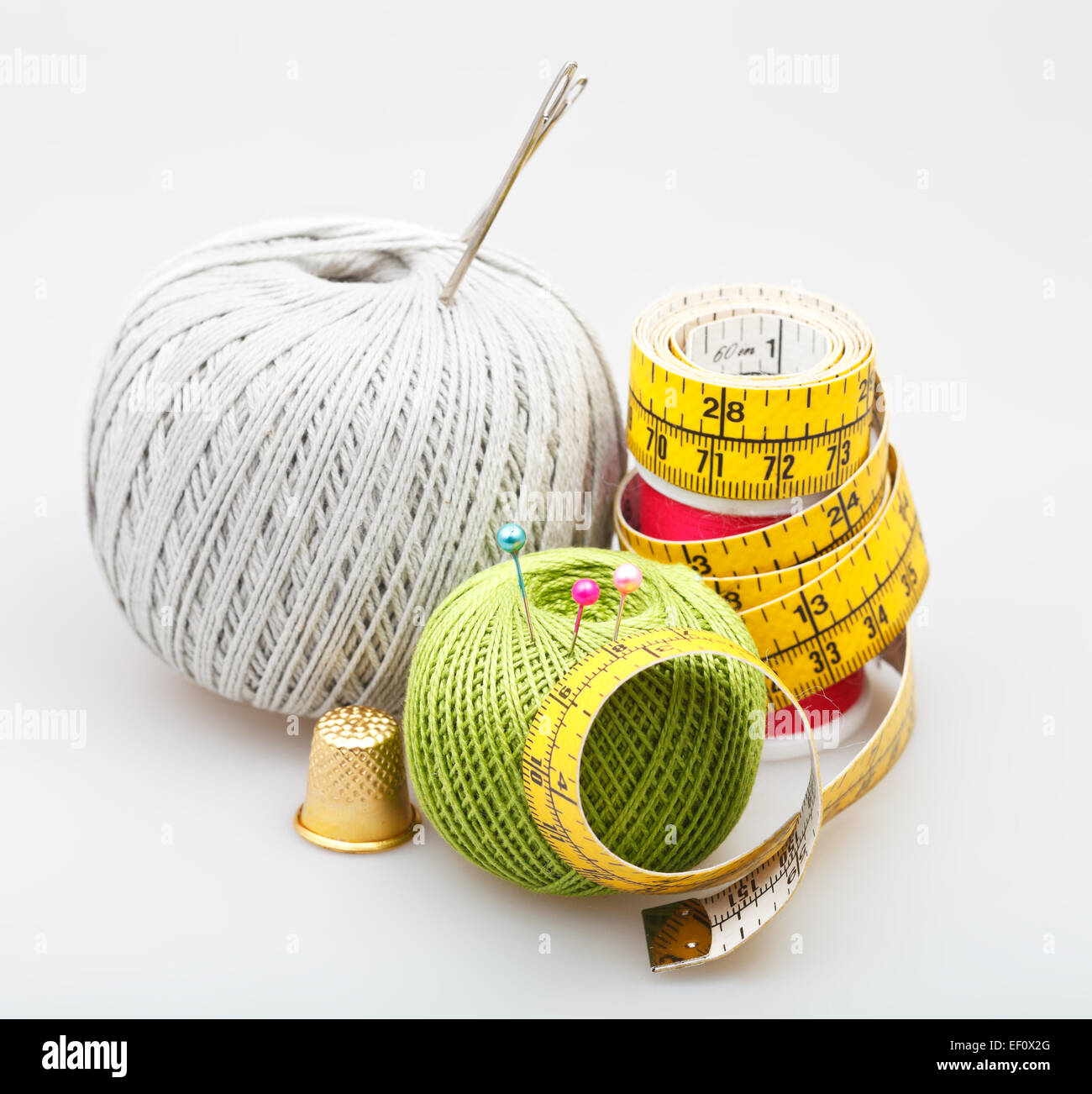 few simple needlework objects on gray background Stock Photo - Alamy