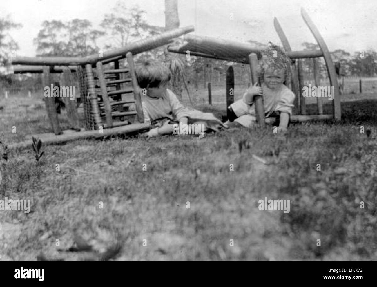 Children are playing under chairs in Babson Park, illustrating a moment ...