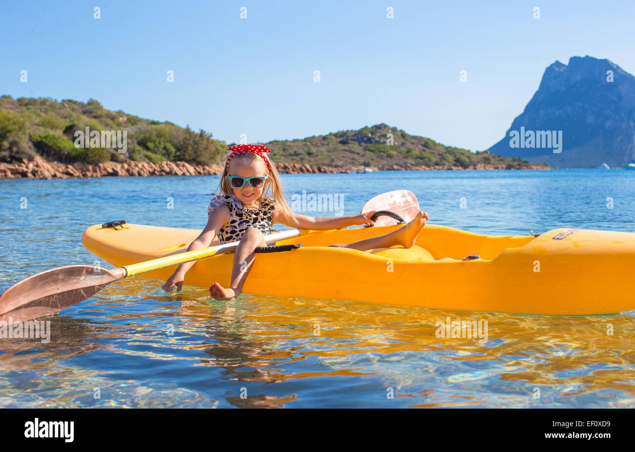Little happy cute girl kayaking in the clear blue sea Stock Photo - Alamy