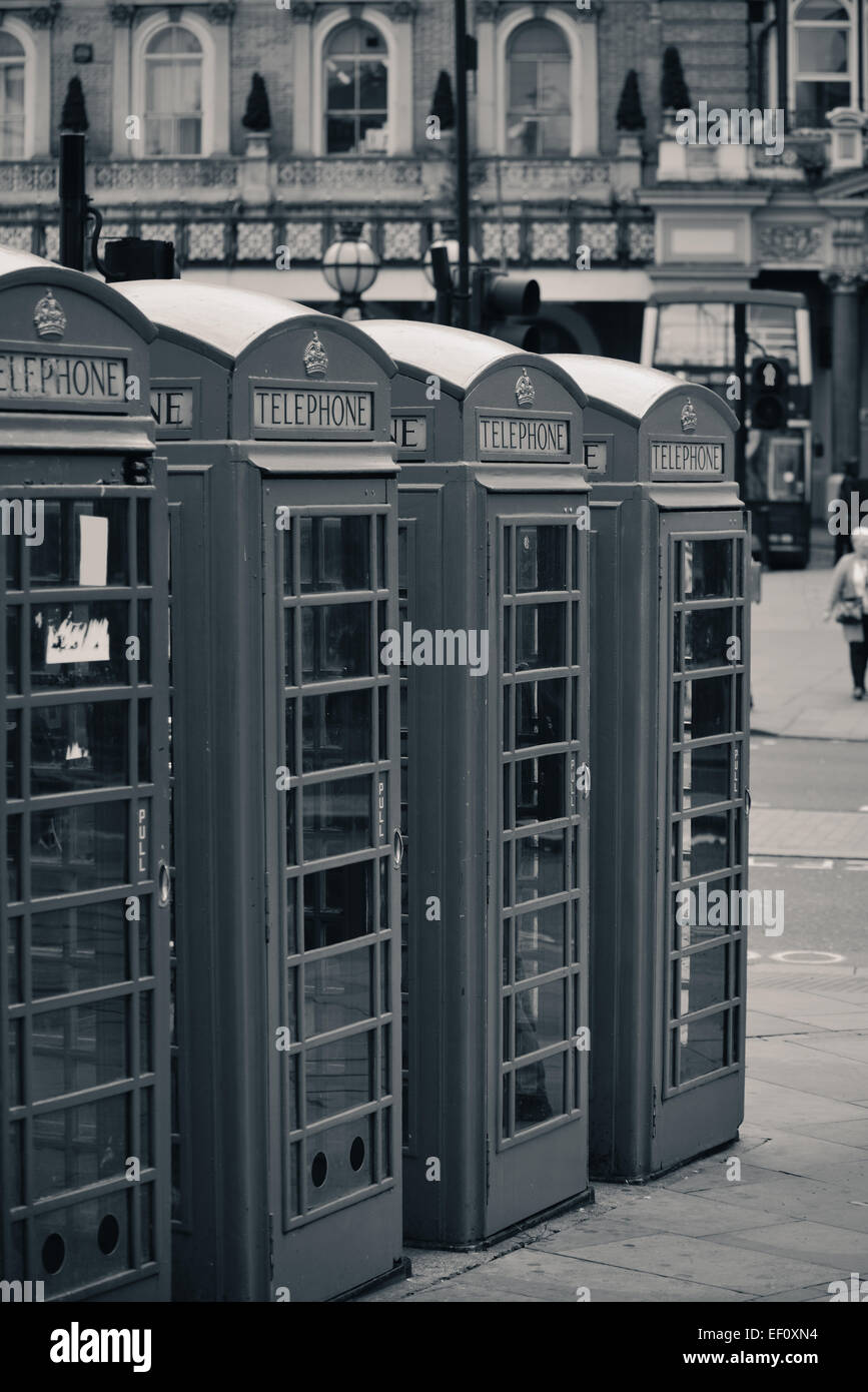 Telephone box in street with historical architecture in London in black ...