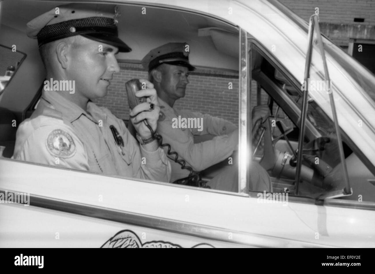 This image features a patrolman in Tallahassee, Florida, using a radio ...