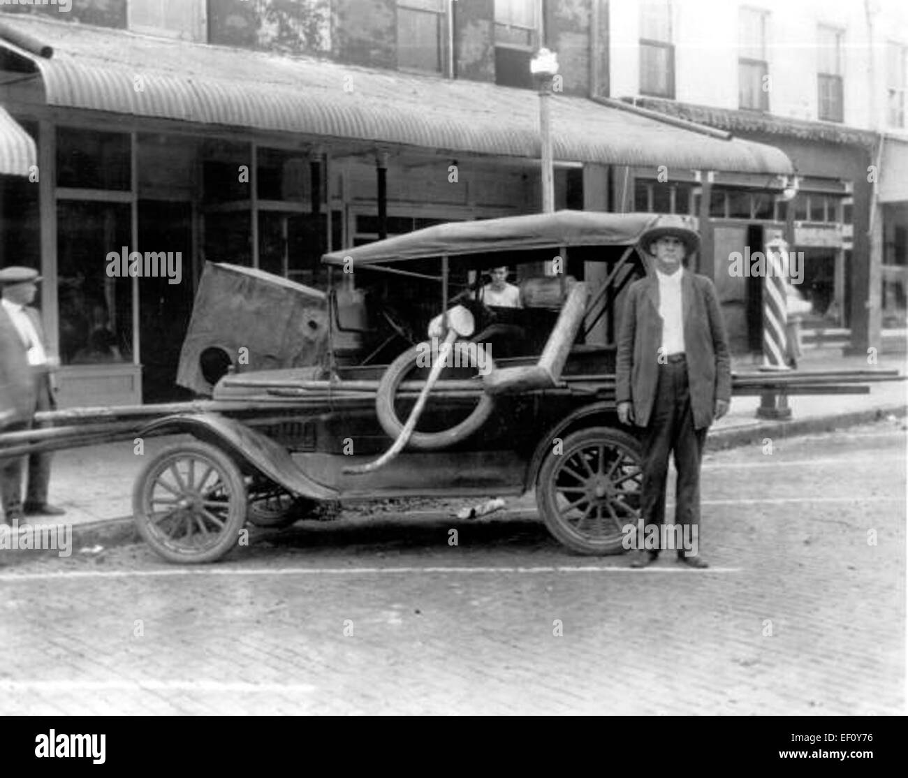 A historical image showing a revenue agent with a confiscated moonshine ...