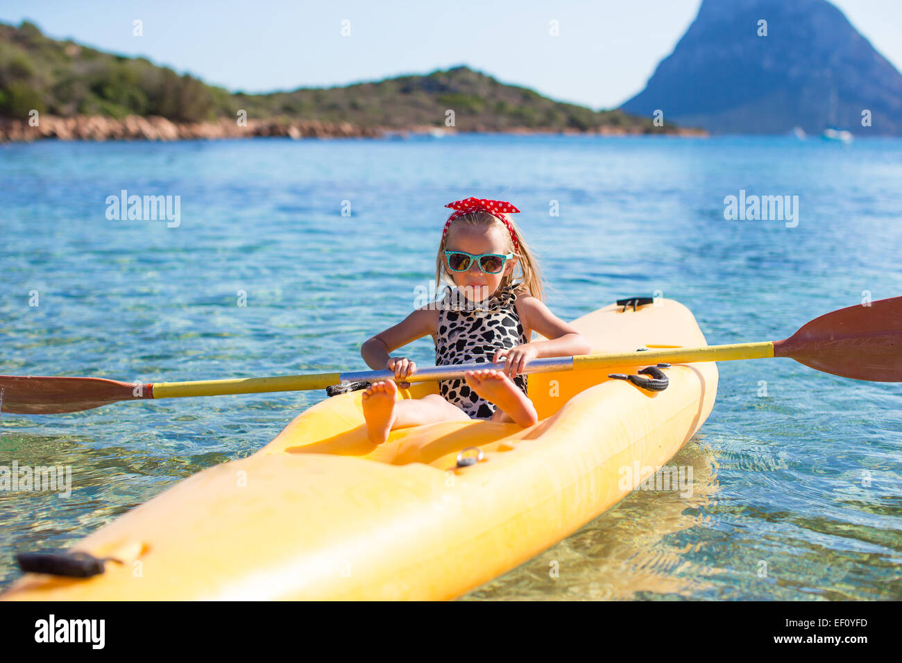 Little happy cute girl enjoy kayaking in the clear blue sea Stock Photo ...