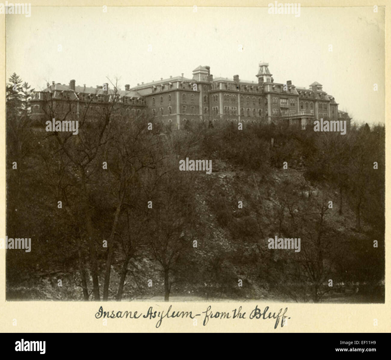This photograph shows the view of an insane asylum taken from a nearby ...