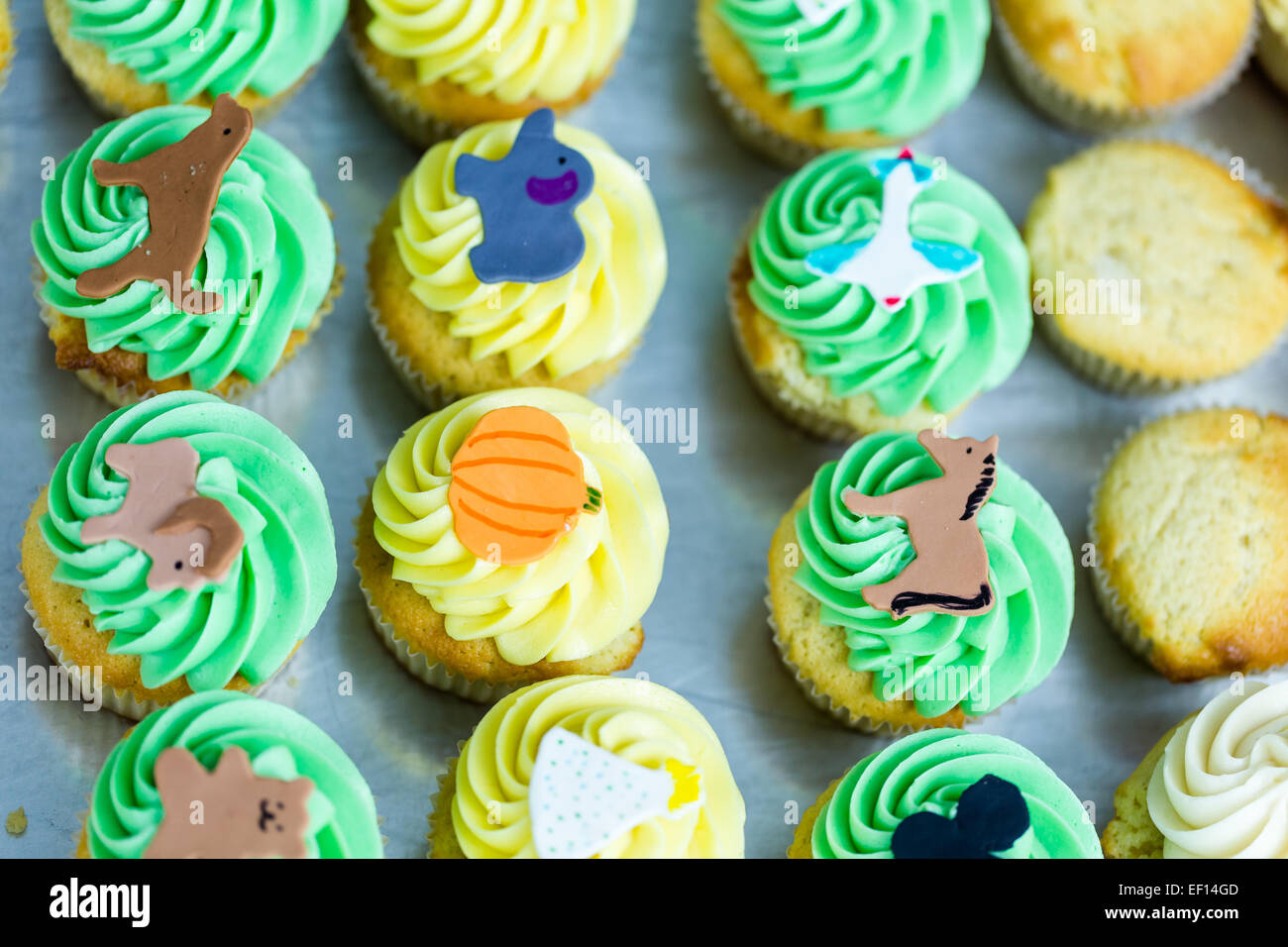 Making multicolor cupcakes for kids birthday party Stock Photo - Alamy
