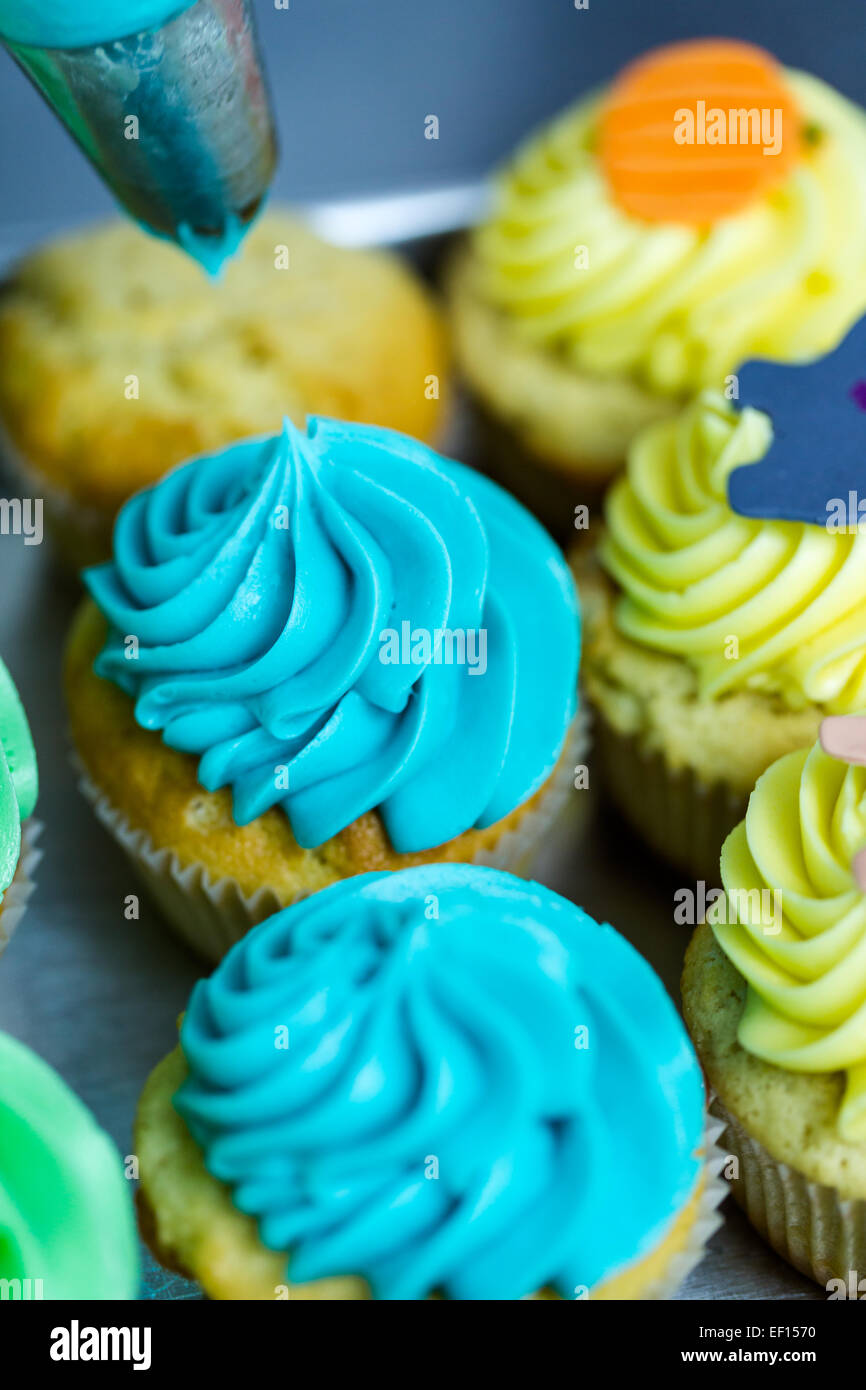 Making multicolor cupcakes for kids birthday party Stock Photo - Alamy