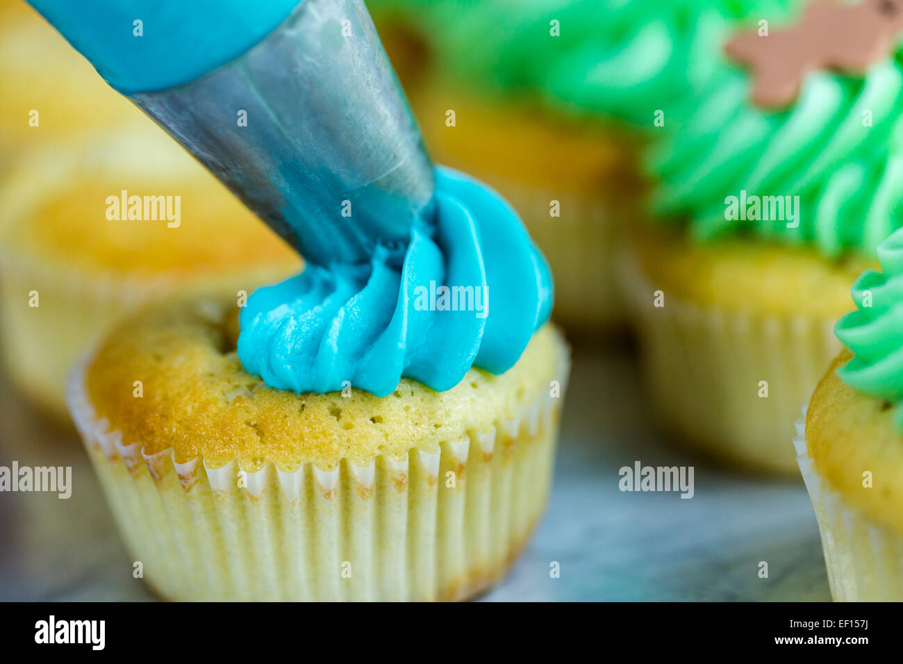 Making multicolor cupcakes for kids birthday party Stock Photo - Alamy