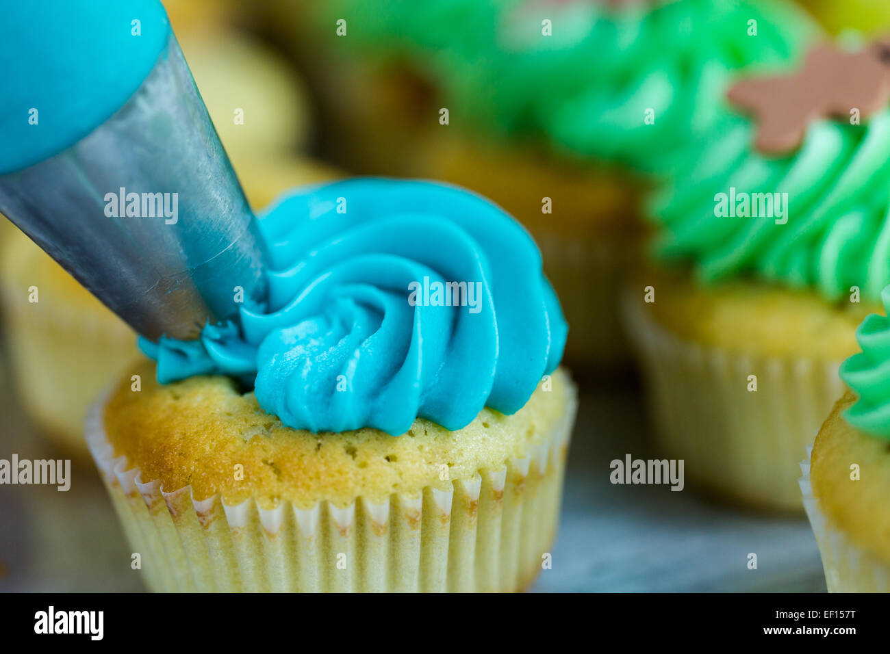Making multicolor cupcakes for kids birthday party Stock Photo - Alamy