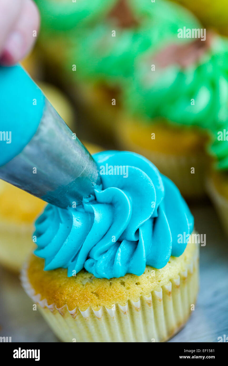 Making multicolor cupcakes for kids birthday party Stock Photo - Alamy