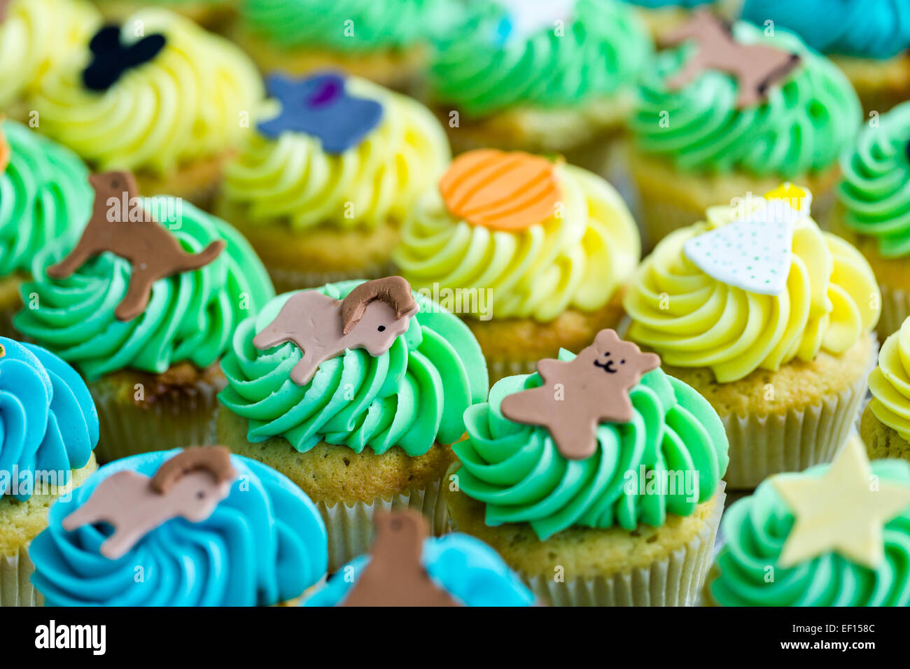 Making multicolor cupcakes for kids birthday party Stock Photo - Alamy