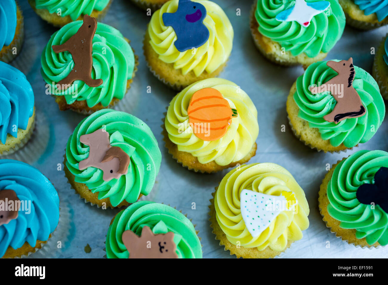 Making multicolor cupcakes for kids birthday party Stock Photo - Alamy