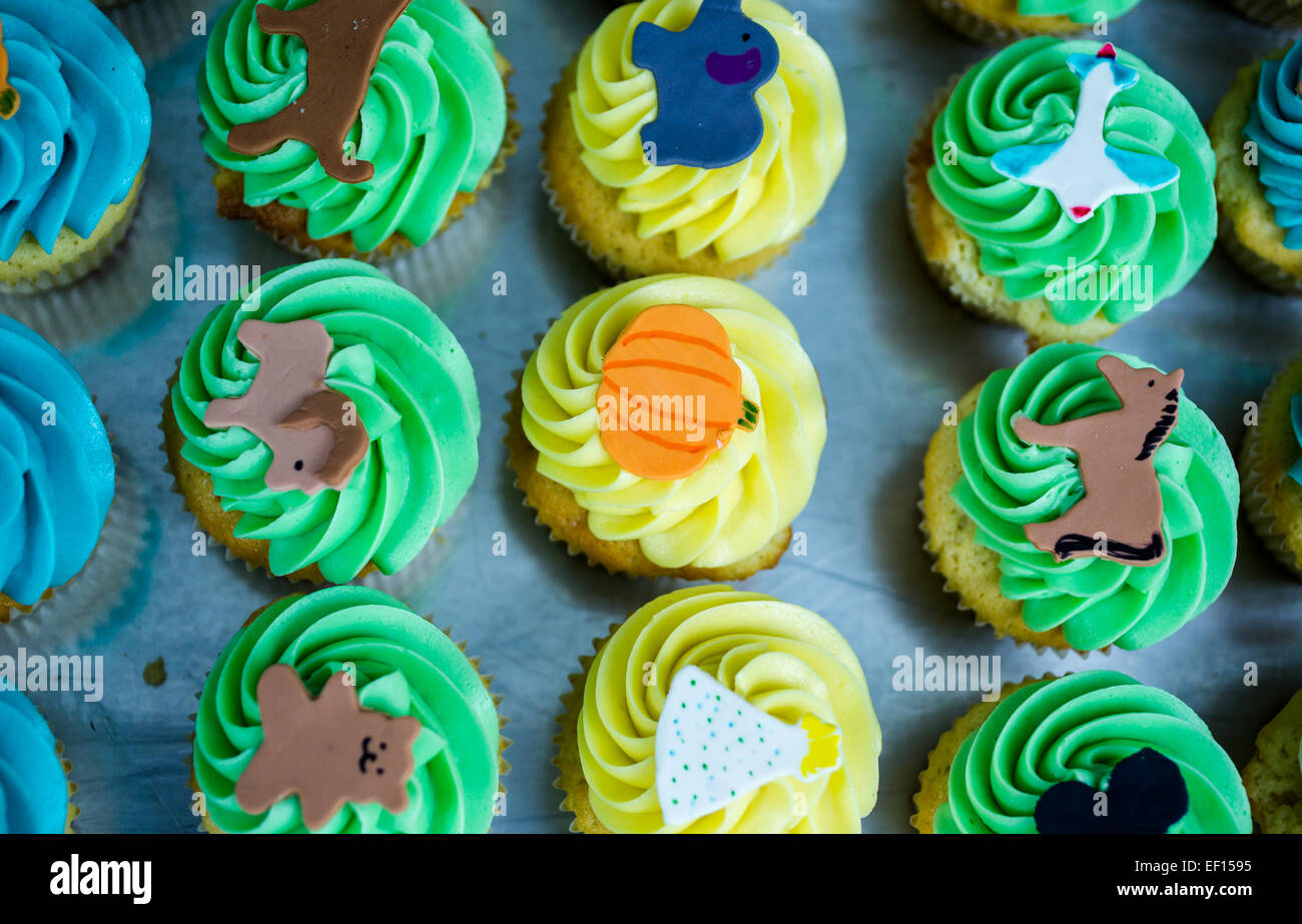 Making multicolor cupcakes for kids birthday party Stock Photo - Alamy