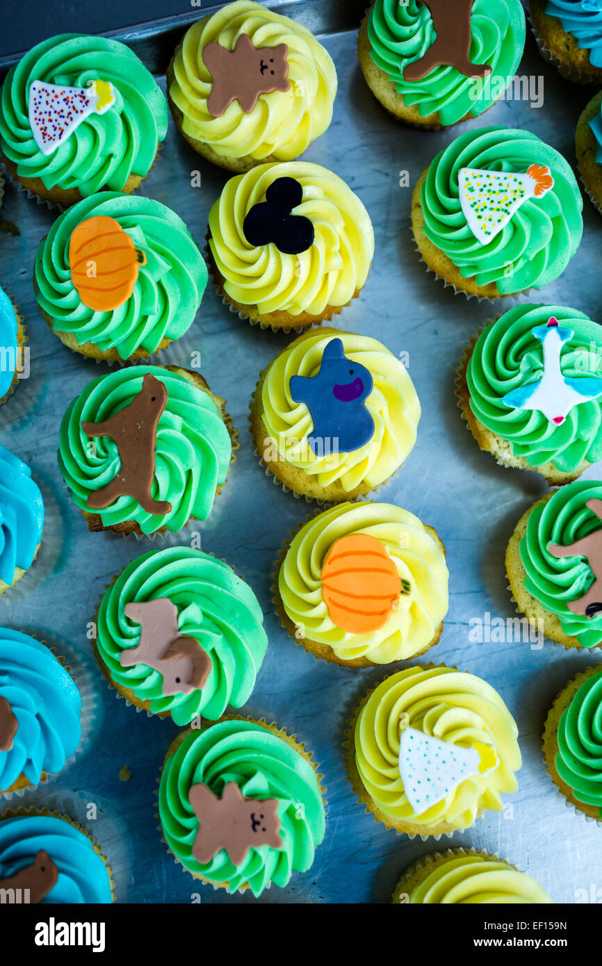Making multicolor cupcakes for kids birthday party Stock Photo - Alamy