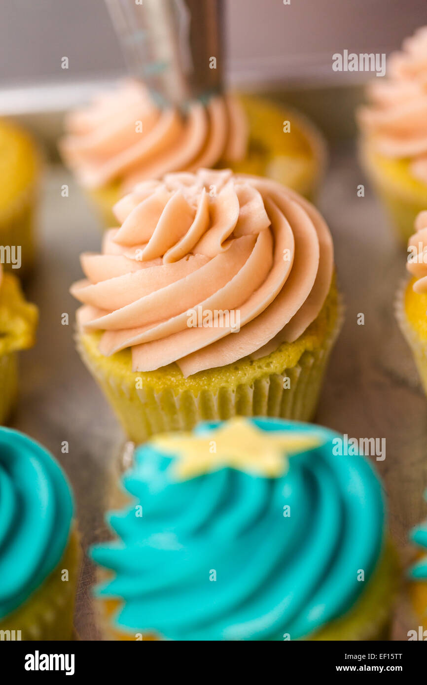 Making multicolor cupcakes for kids birthday party Stock Photo - Alamy