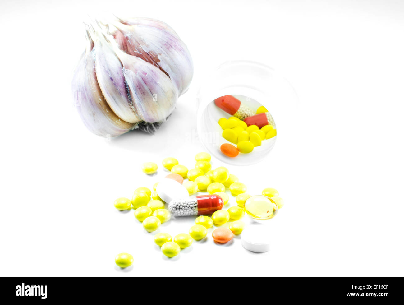 rash pill bottles with garlic on a white background Stock Photo - Alamy