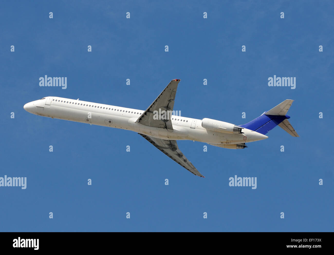 Passenger jet airplane taking off against blue sky Stock Photo - Alamy