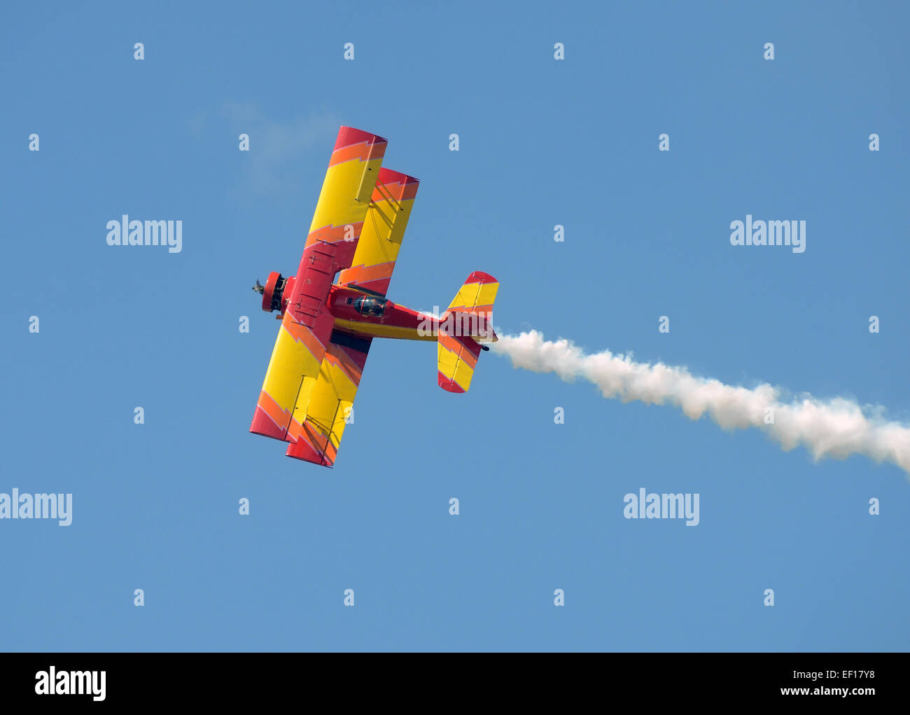 Old biplane in bright colors performing stunts Stock Photo - Alamy