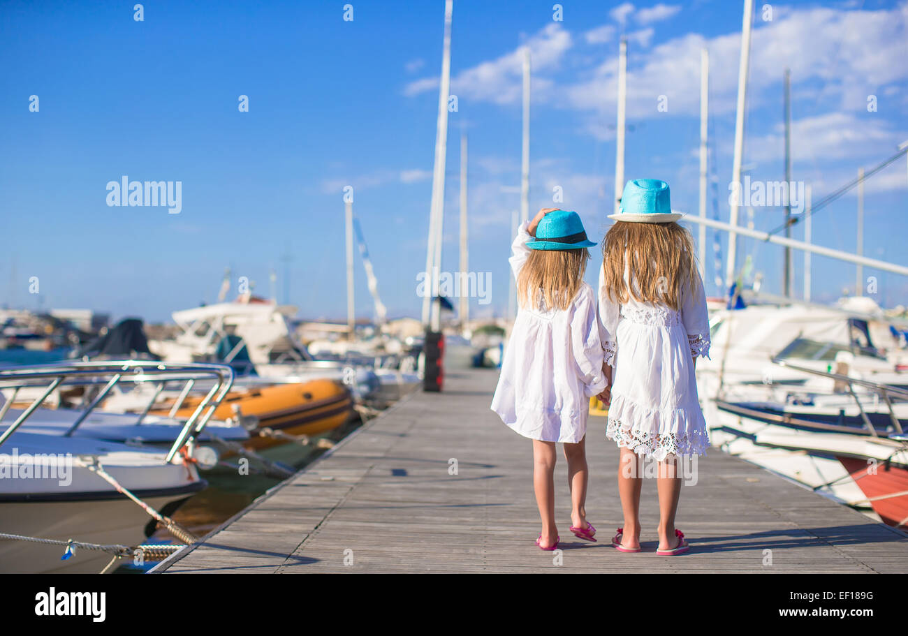 Adorable little girls walking in a port on summer day Stock Photo - Alamy