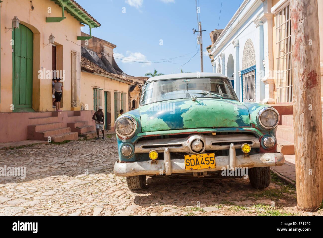 View of typical battered, old, rusty green vintage American car parked ...