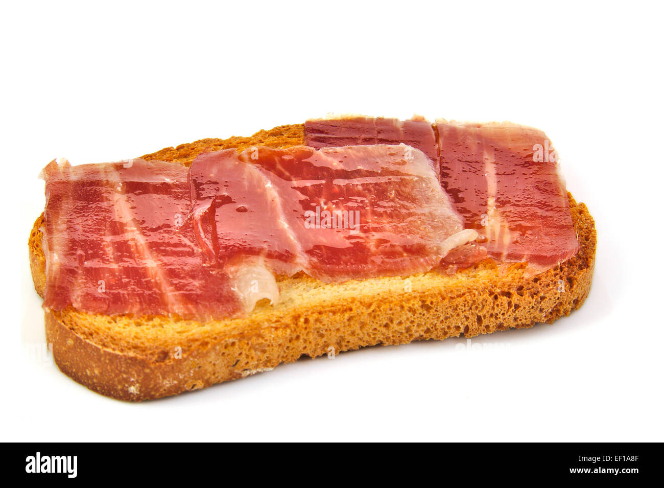 Spanish serrano ham on bread slice. White background. Spanish tapa ...