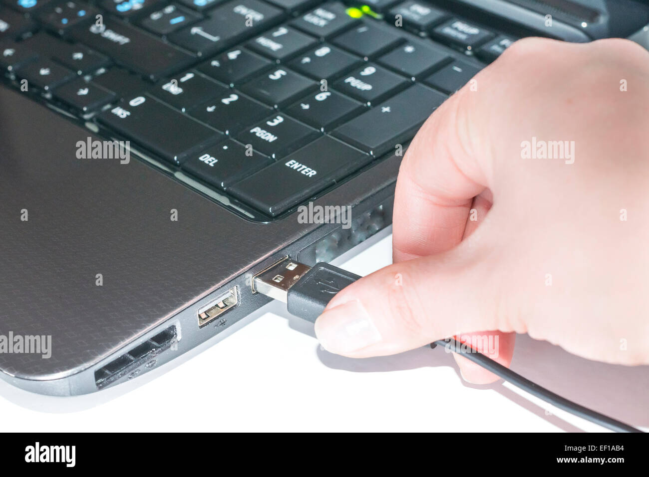 arm connects usb cable Stock Photo - Alamy