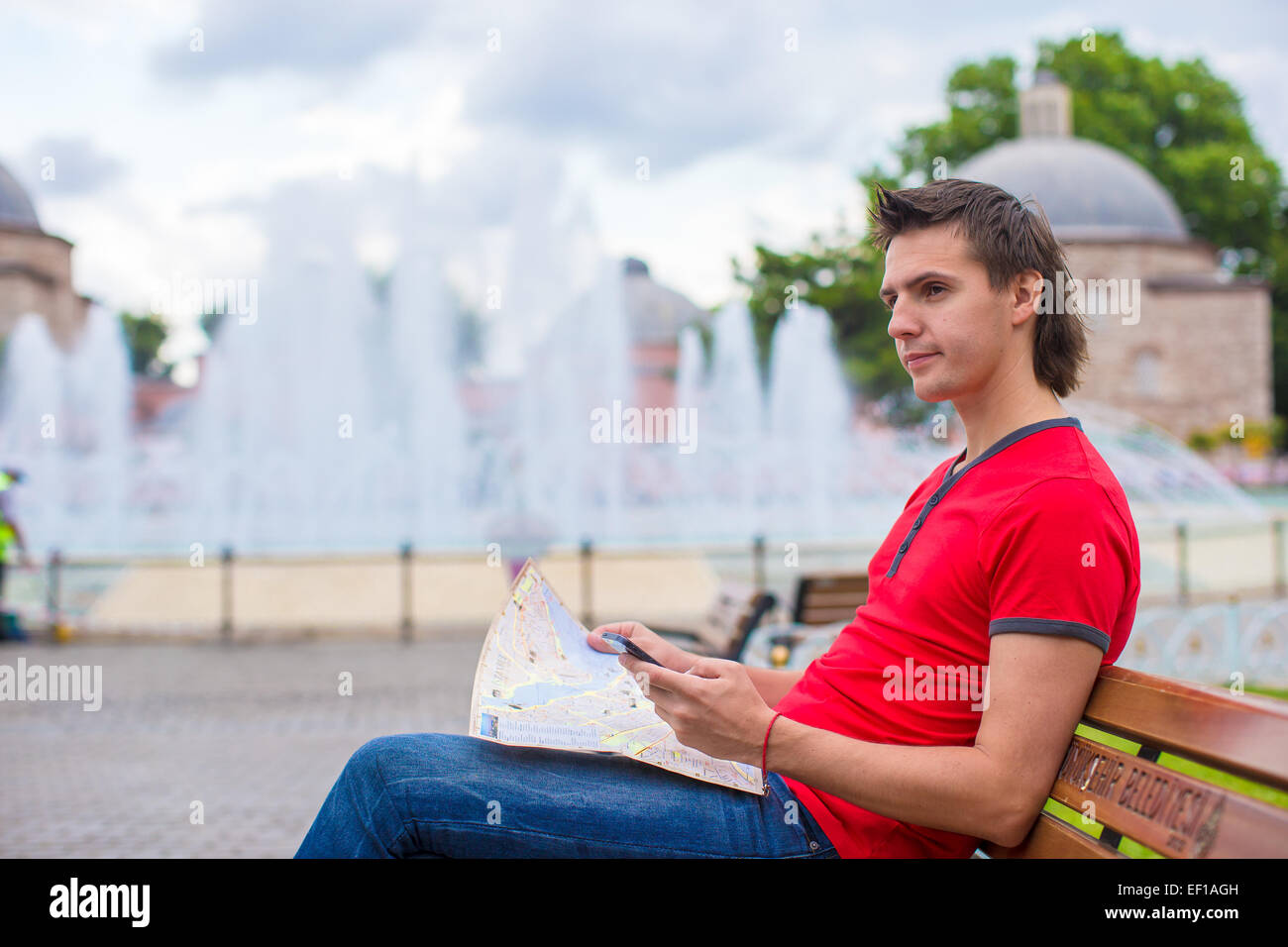Man looking at city map on a trip Stock Photo - Alamy
