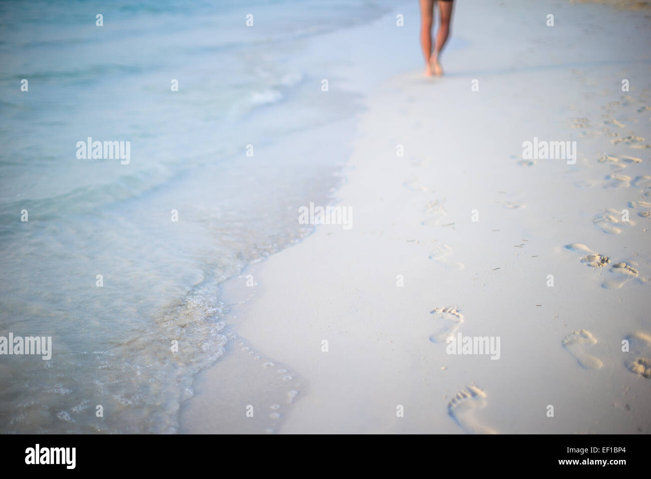 Human footprints on white sand beach Stock Photo - Alamy