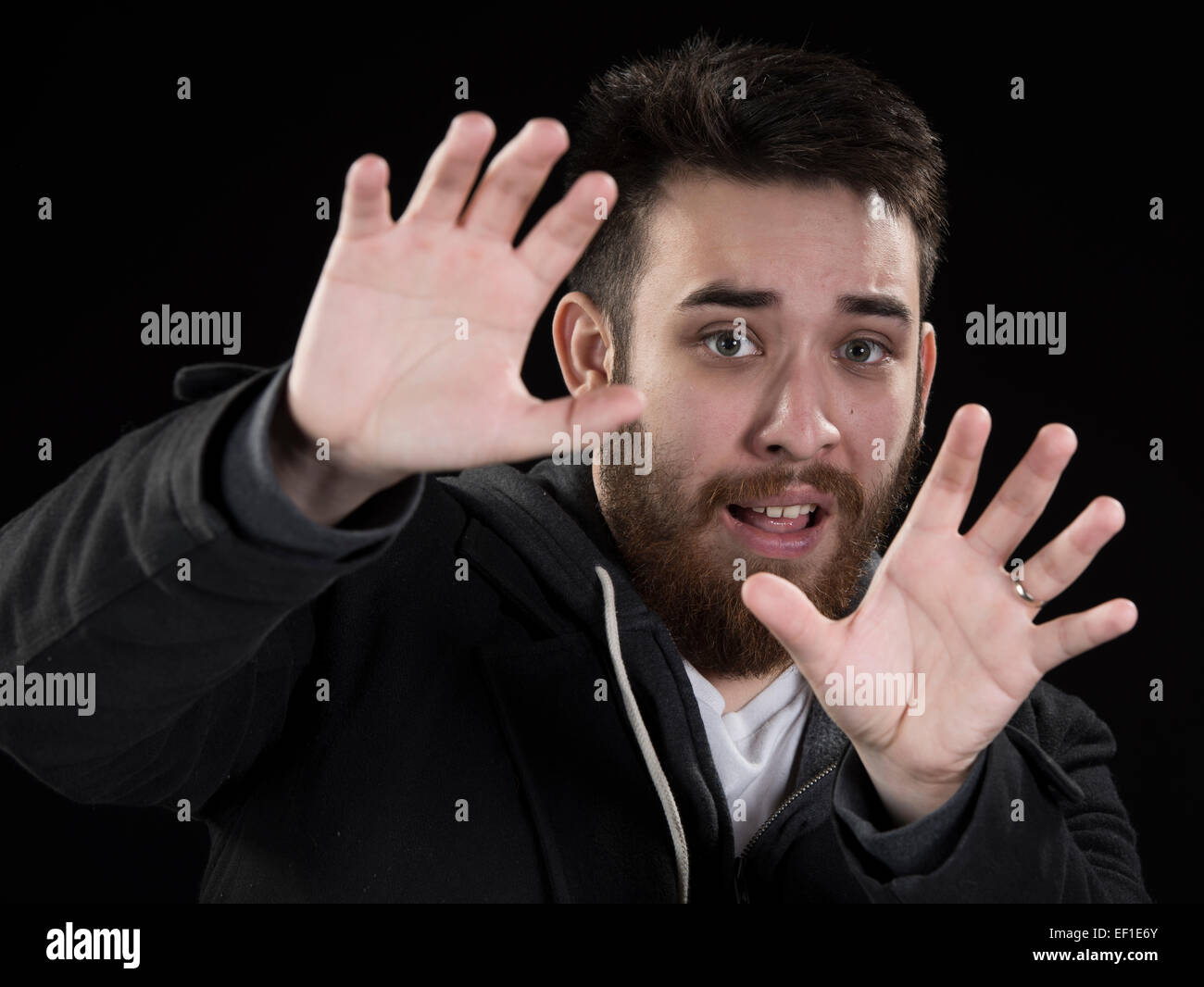 Afraid Young Man with Hands Up Stock Photo - Alamy
