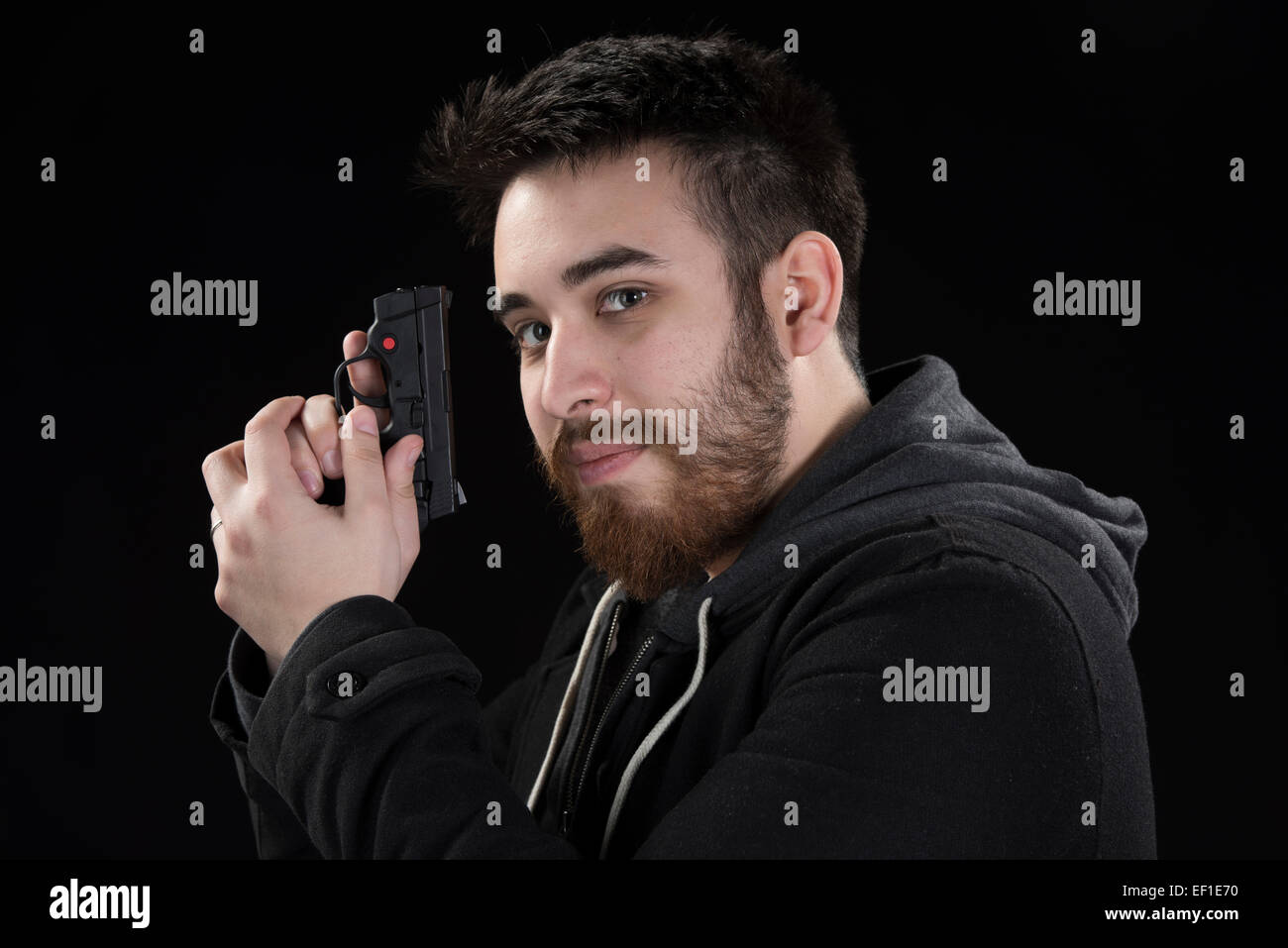 Goatee Young Man in Jacket Holding Small Gun Stock Photo - Alamy